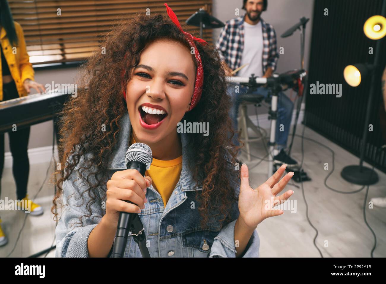 Music band performing in modern recording studio Stock Photo - Alamy
