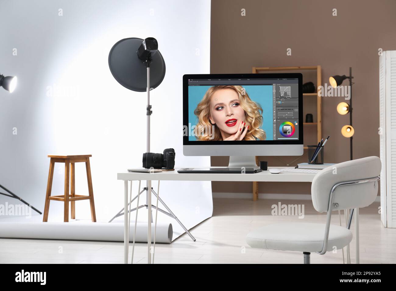 Retoucher's workplace. Computer with photo editor application, camera ...