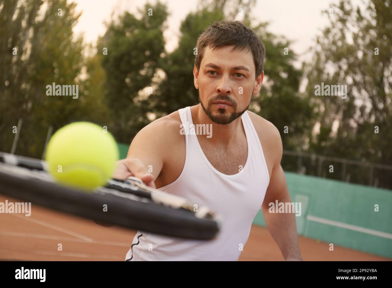 Handsome man playing tennis hi-res stock photography and images - Alamy