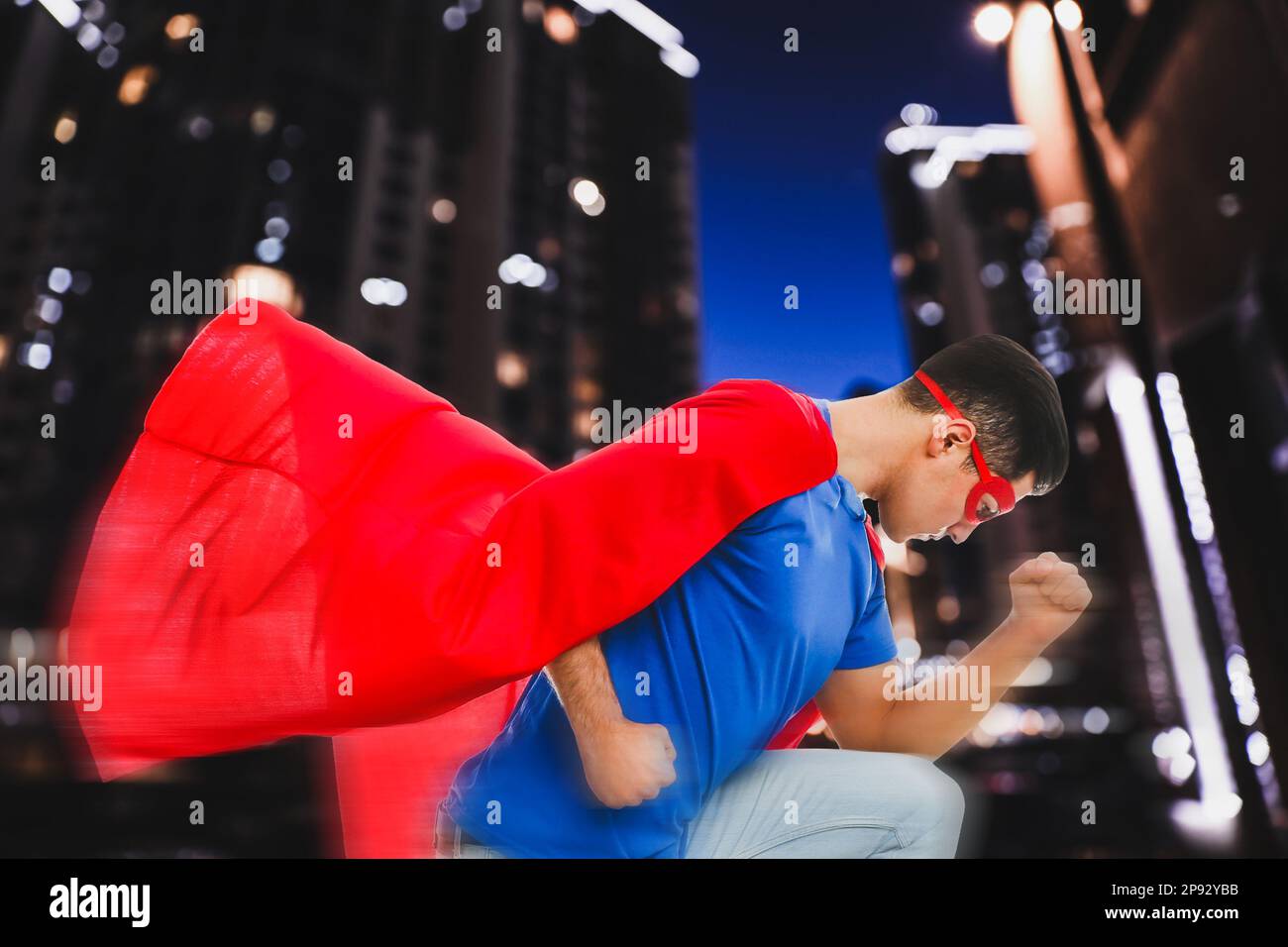 Man wearing superhero costume and beautiful cityscape in night on ...