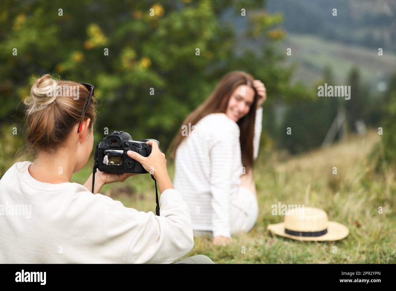 Professional photographer working with model in nature Stock Photo - Alamy