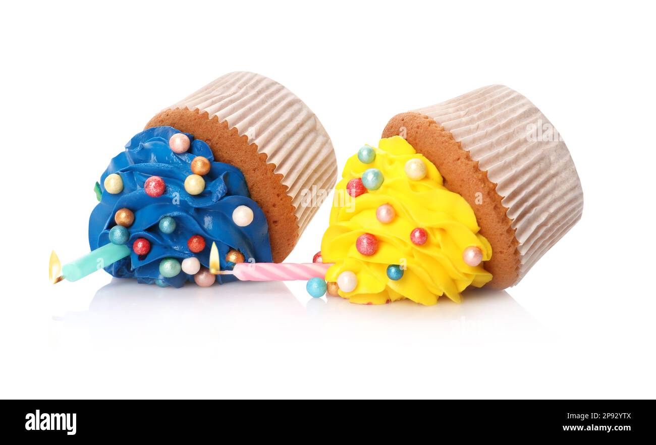 Dropped cupcakes with candles on white background. Troubles happen ...