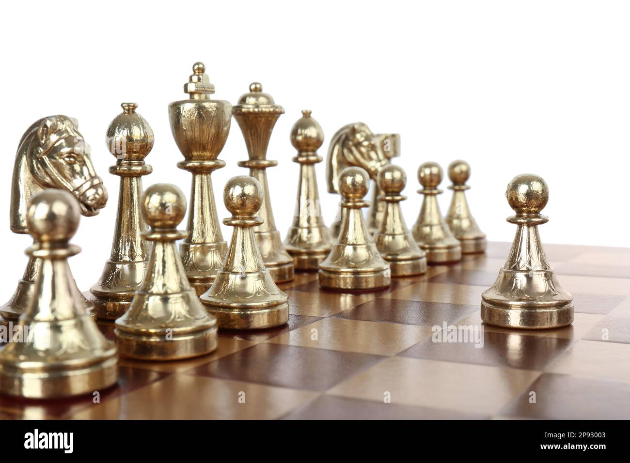 Pawn in front of other chess pieces on wooden board against white ...