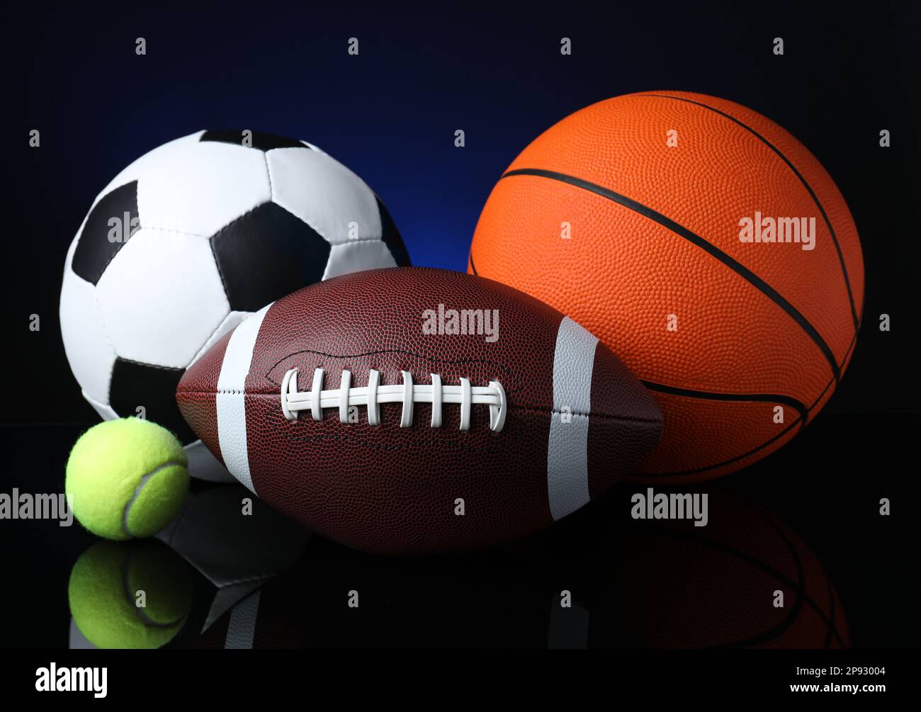 Set of different sport balls on black mirror surface Stock Photo - Alamy