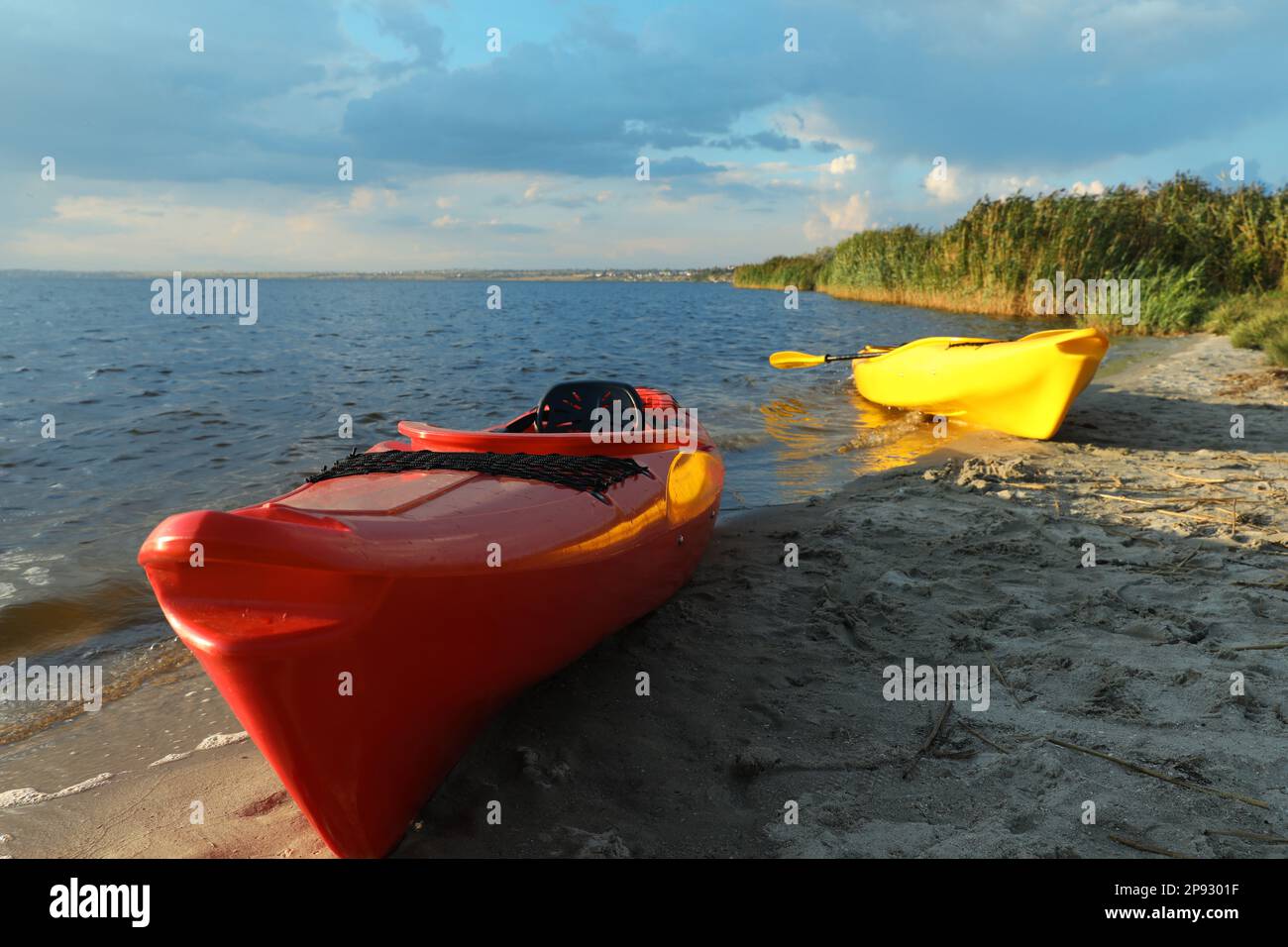 Beautiful modern kayaks on beach near river Stock Photo - Alamy