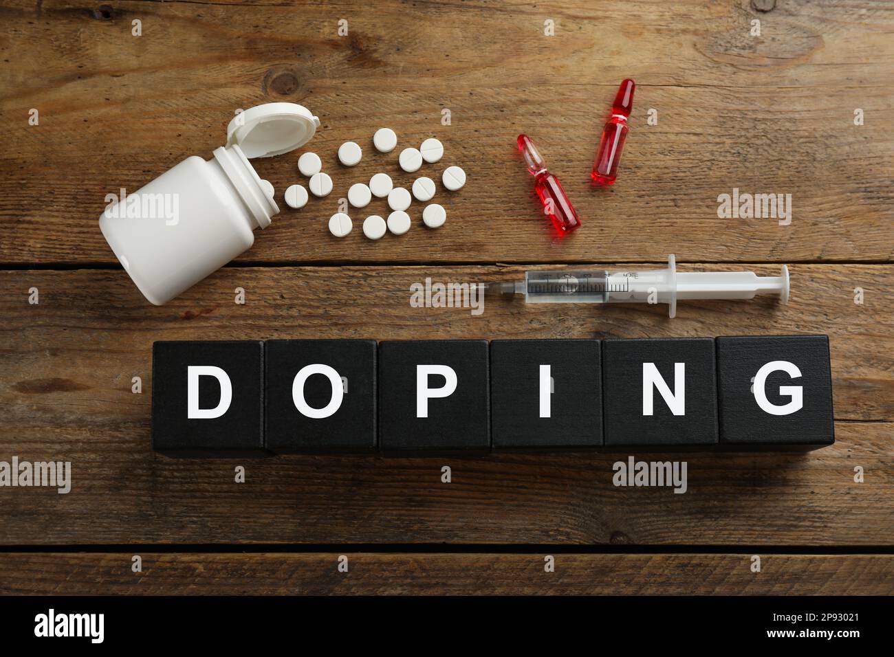Black cubes with word Doping and drugs on wooden background, flat lay ...