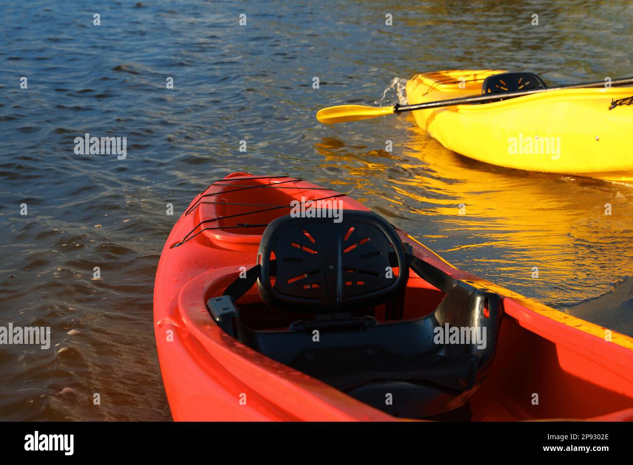 Beautiful modern kayaks on beach near river Stock Photo - Alamy