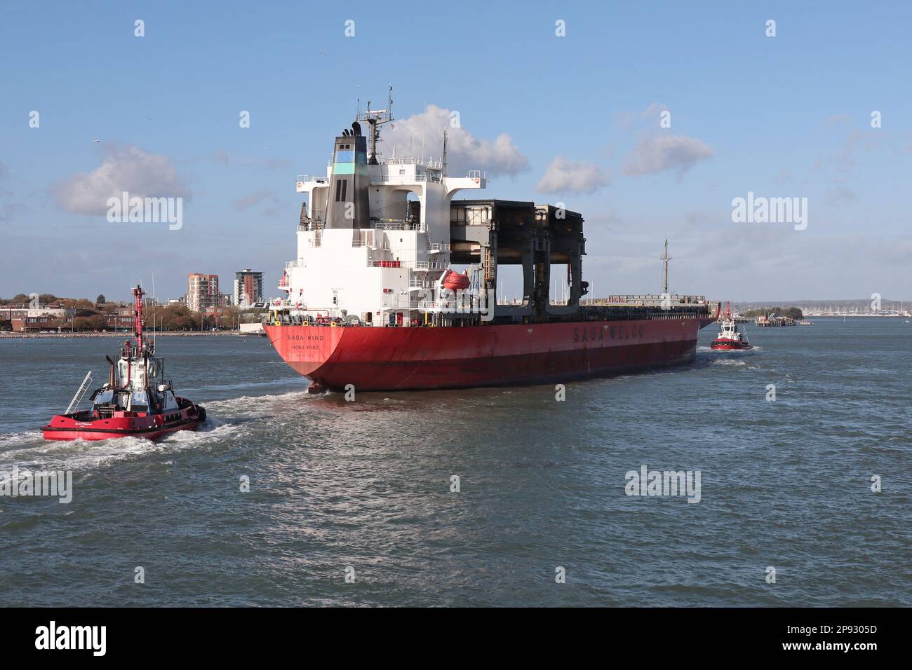 Tugs guide the Hong Kong registered general cargo vessel MV SAGA WIND ...