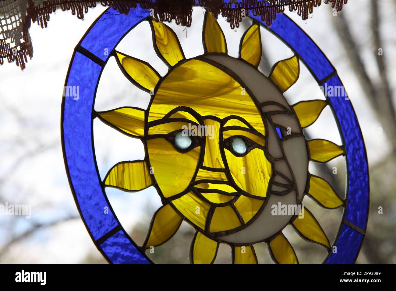 Sun and moon stained glass piece hanging in kitchen window Stock Photo ...