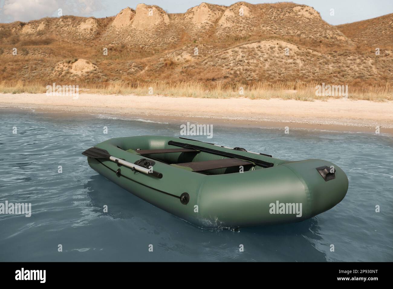 Inflatable rubber fishing boat floating in sea near coast Stock Photo ...