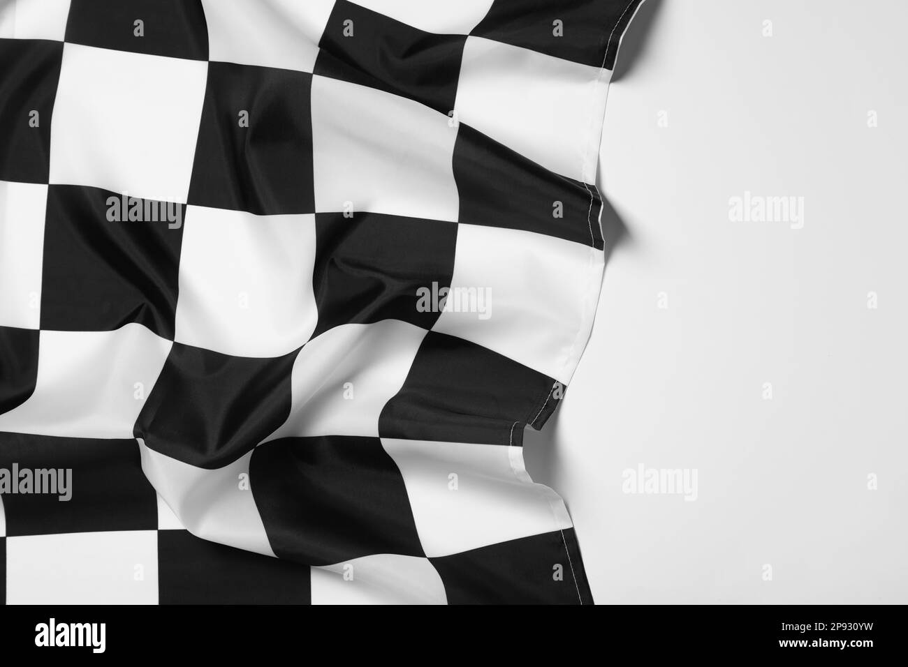 Checkered finish flag on white background, top view. Space for text ...