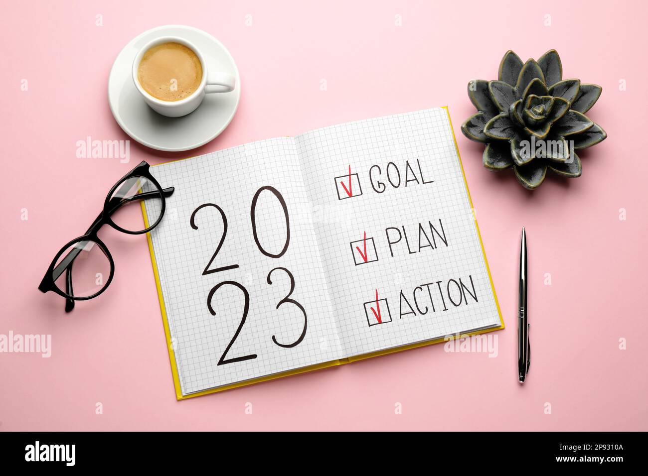 Flat lay composition of notebook with text 2023 Goal, Plan, Action on pink background. New Year ...