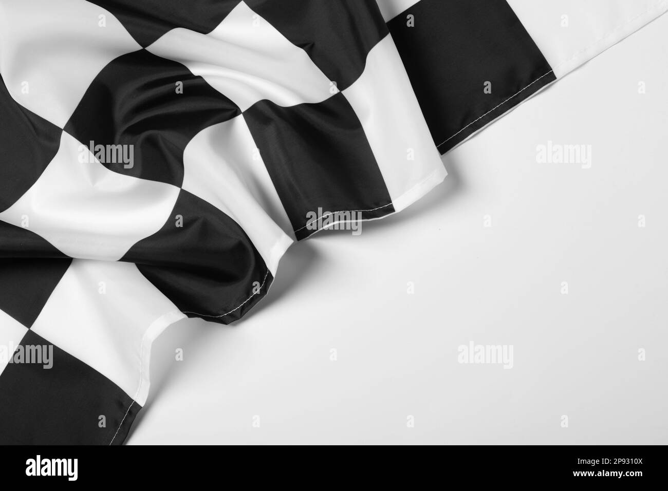 Checkered finish flag on white background, top view. Space for text Stock Photo - Alamy