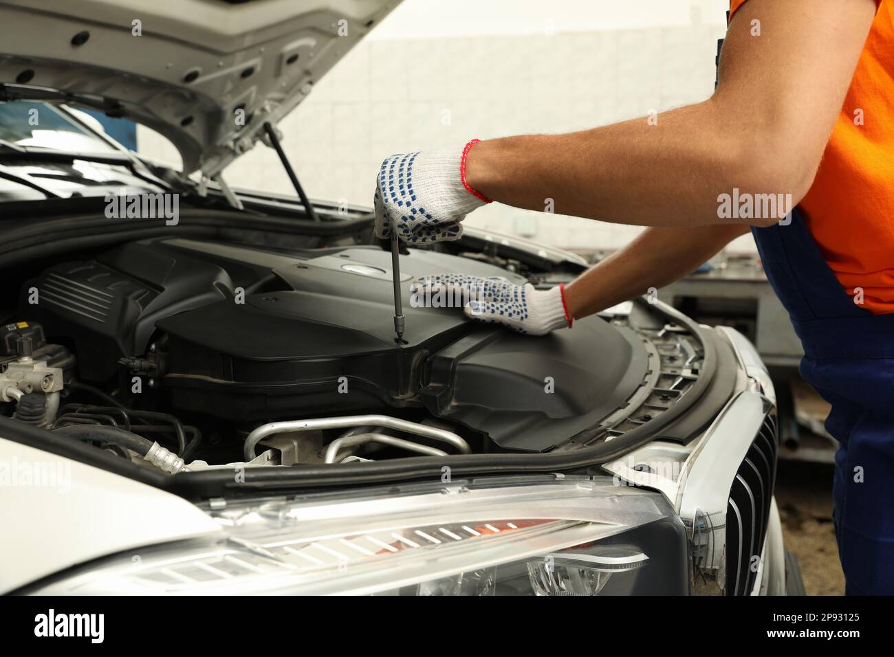 Professional mechanic fixing modern car at automobile repair shop ...