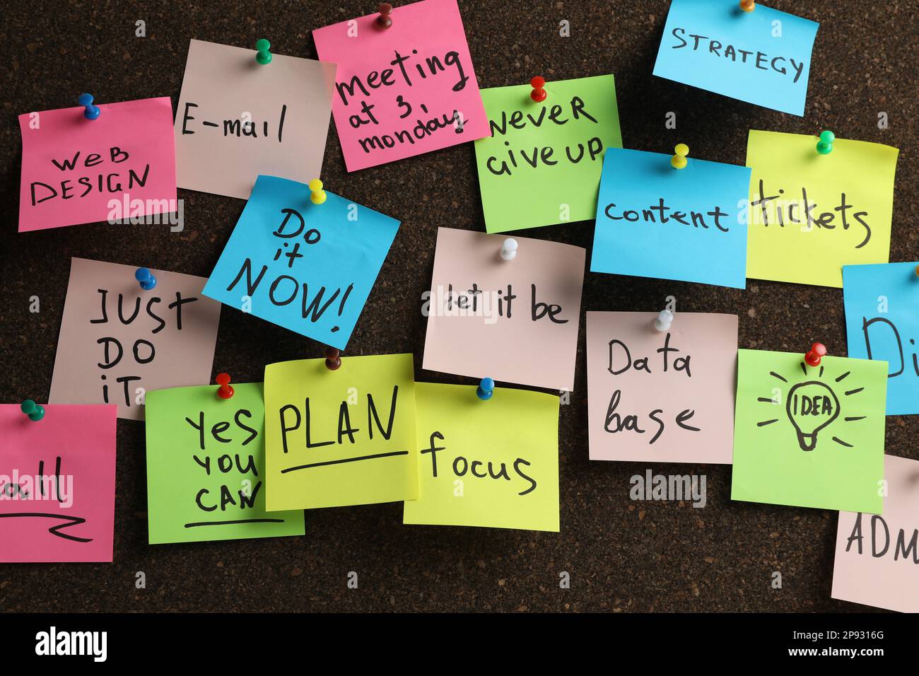 Colorful reminder notes pinned to cork board Stock Photo - Alamy