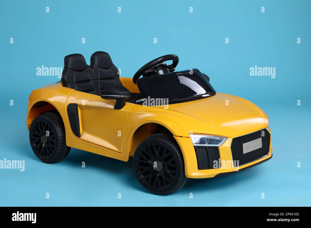 Toy yellow car on light blue background Stock Photo - Alamy