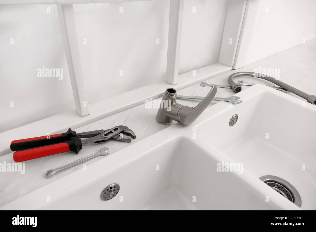 Plumber's tools and water tap ready for installation near sink on ...