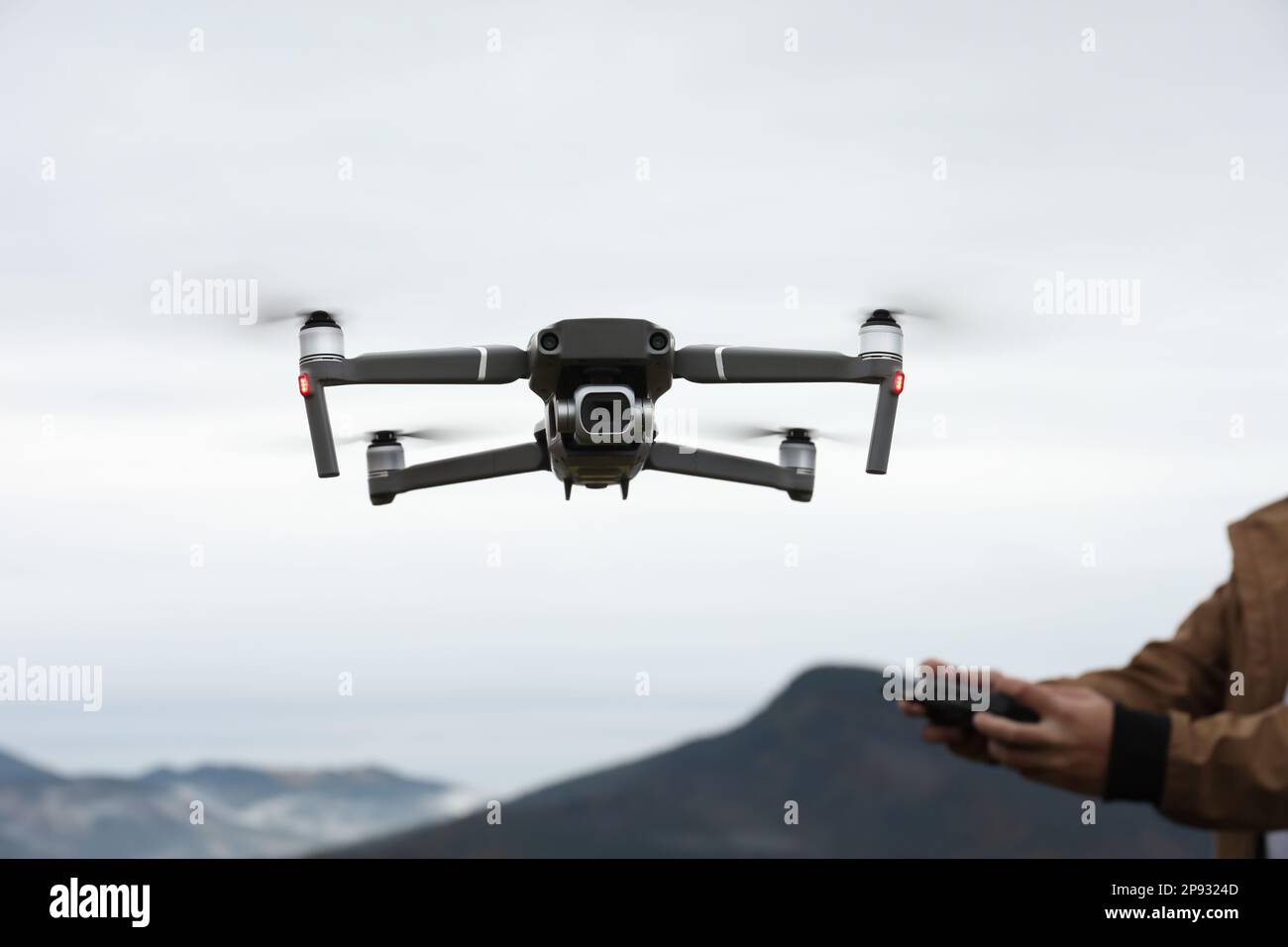 Operating drone in mountains hi-res stock photography and images - Alamy