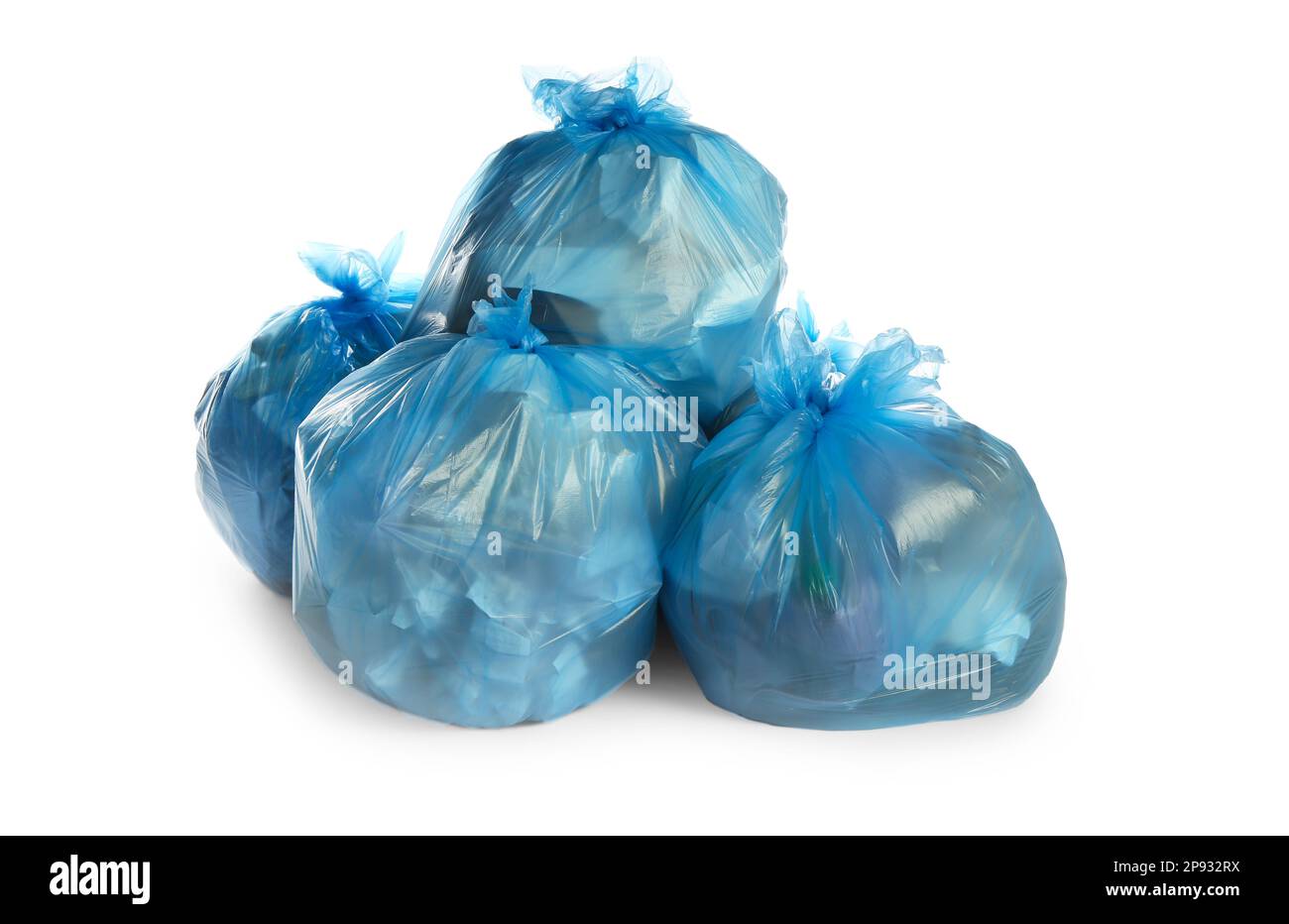 Blue trash bags filled with garbage on white background Stock Photo - Alamy
