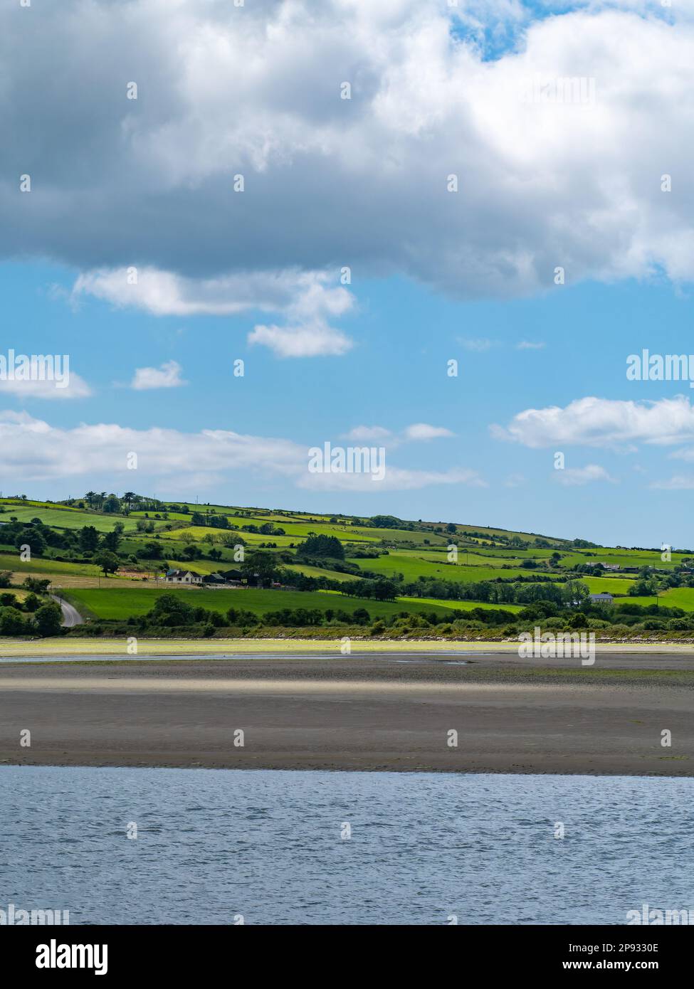 White clouds in the sky, countryside. Green hills on a summer. Irish ...