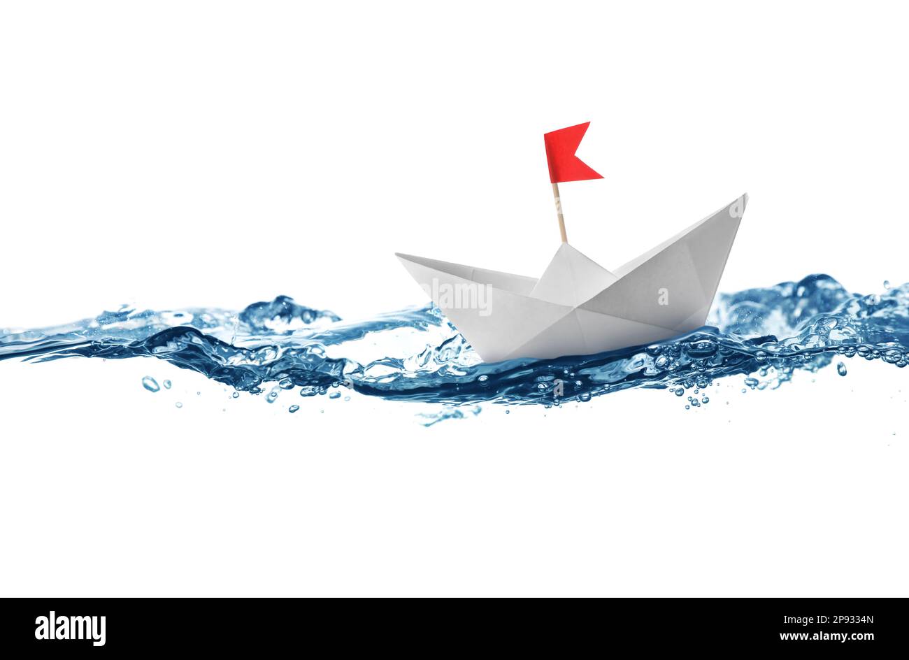 Handmade paper boat floating on clear water against white background ...