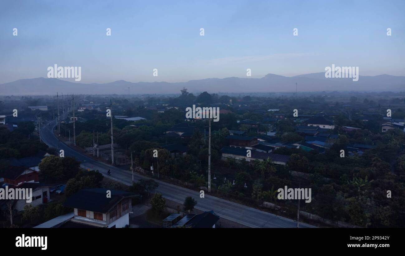 Aerial view of a rural village shrouded in smog from burning activities ...