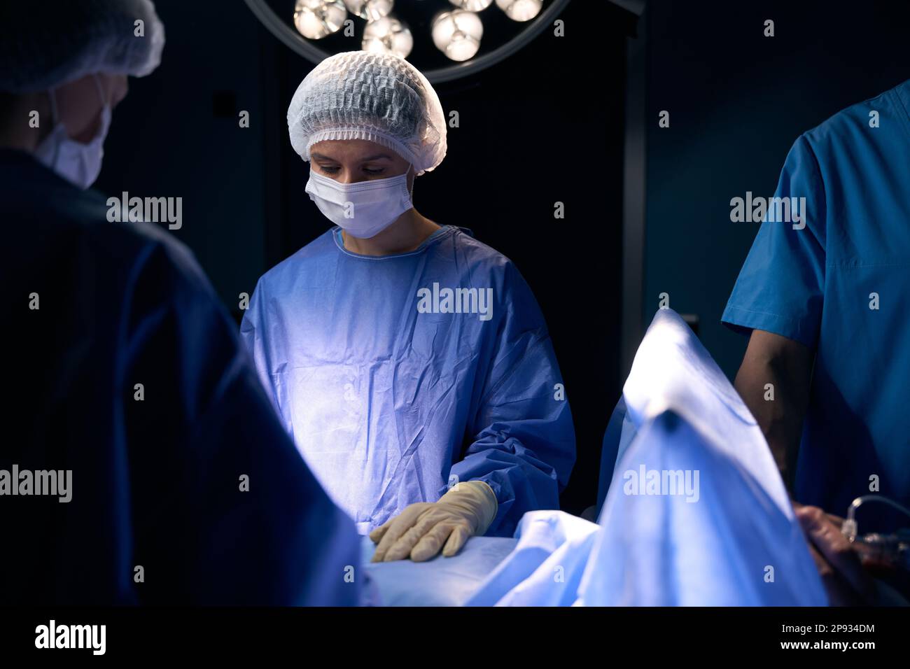 Nurse in an operating uniform stands at the surgical table Stock Photo ...