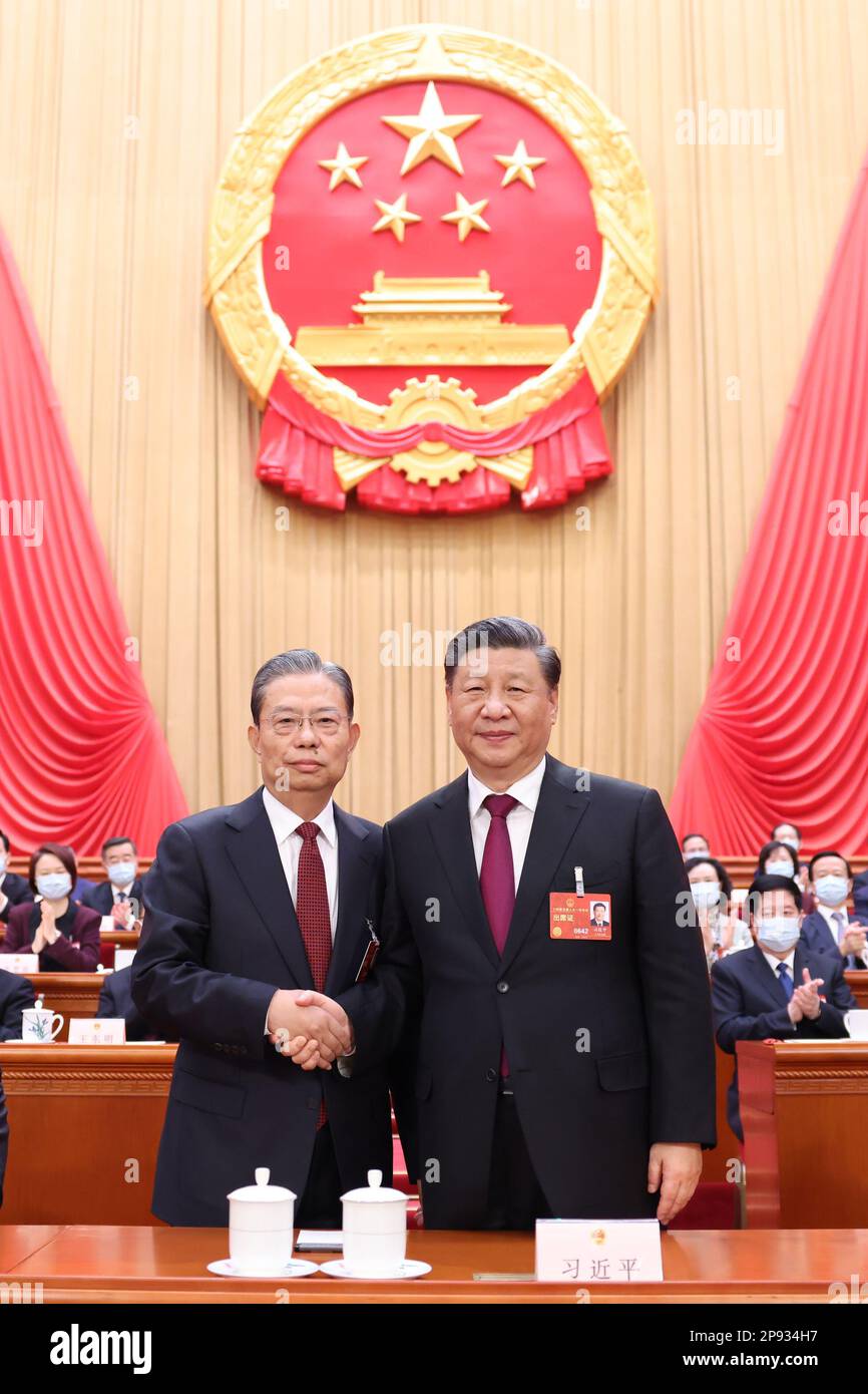 Beijing, China. 10th Mar, 2023. Xi Jinping shakes hands with Zhao Leji ...