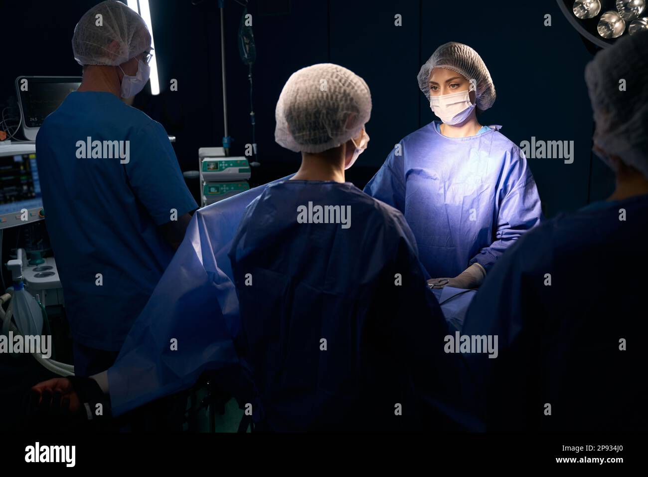 Group of people in surgical overalls stand at operating table Stock ...