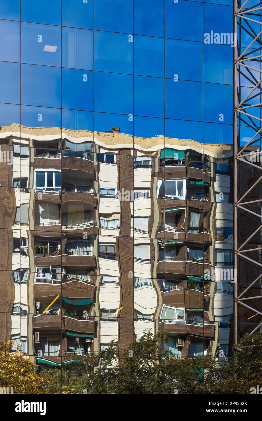 Buildings reflected in the glasses of the facade of a modern building ...