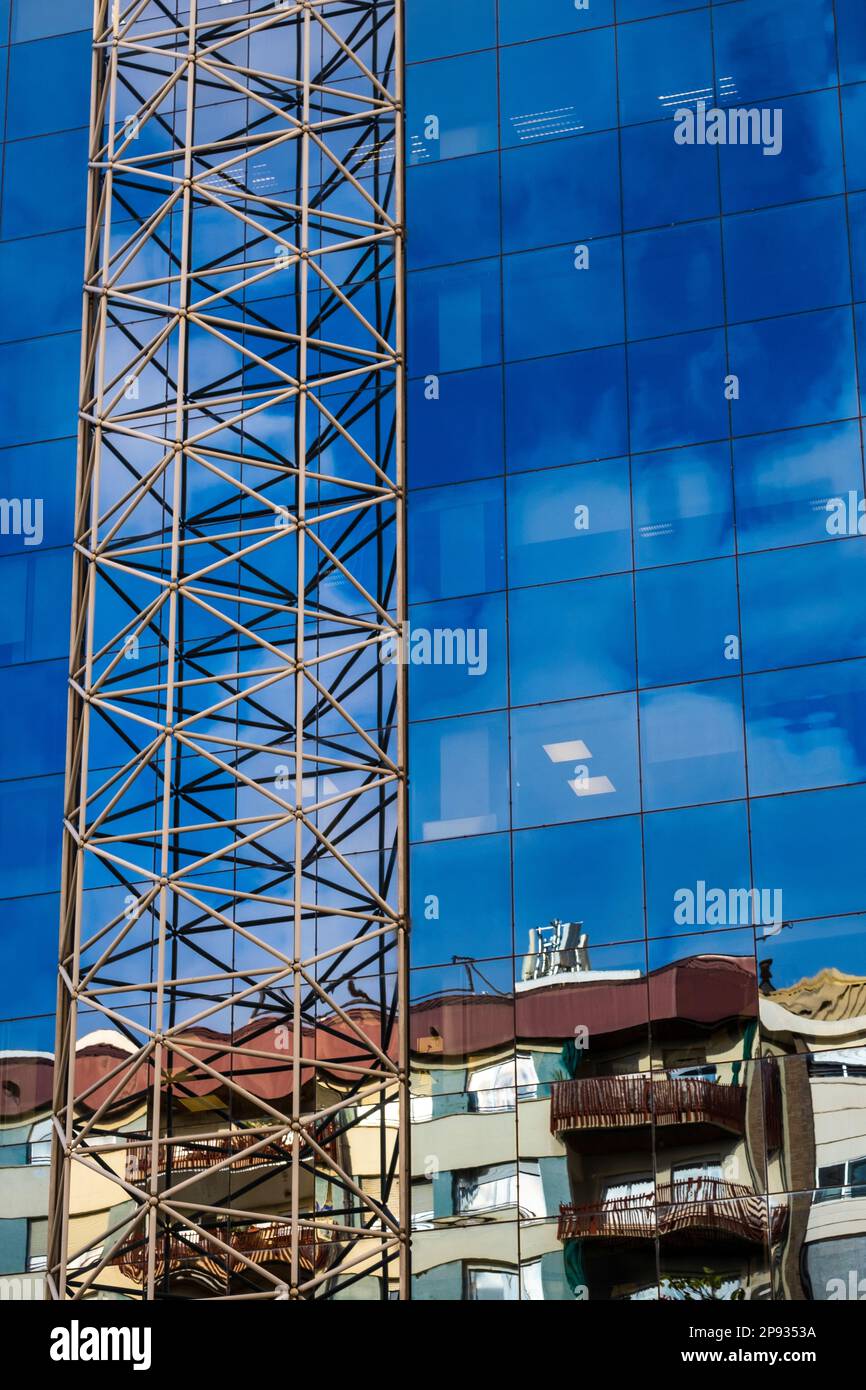Buildings reflected in the glasses of the facade of a modern building ...