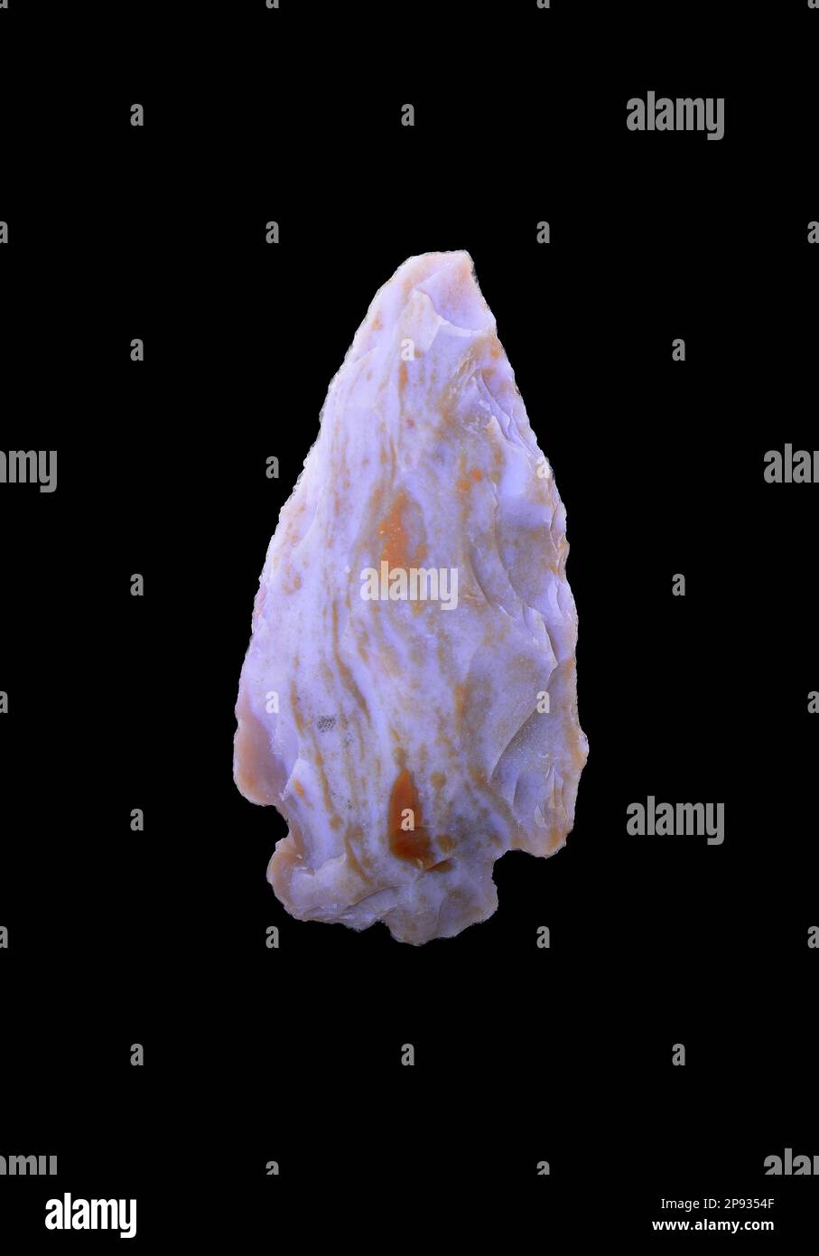 Ancient Prehistoric primitive stone arrowhead isolated over black Stock ...