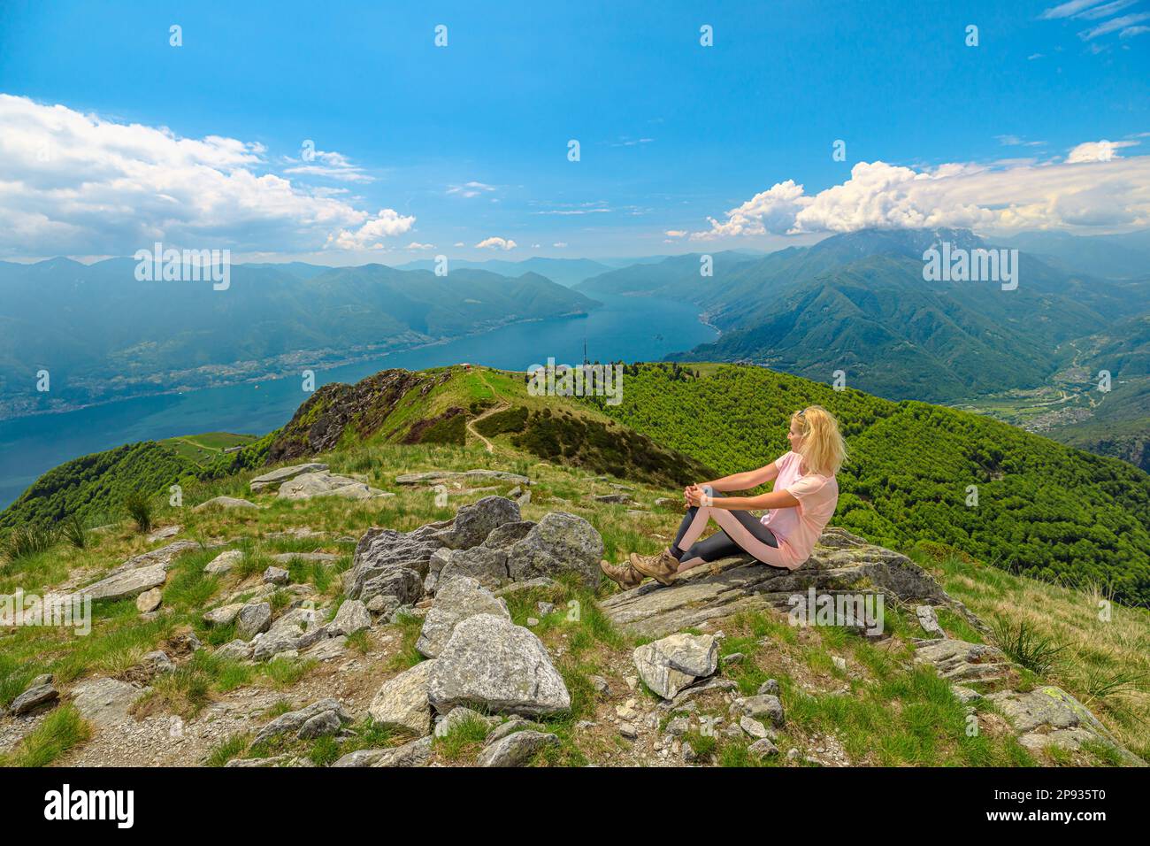 Woman relaxing on top of Cardada-Cimetta mount in Switzerland. Swiss ...