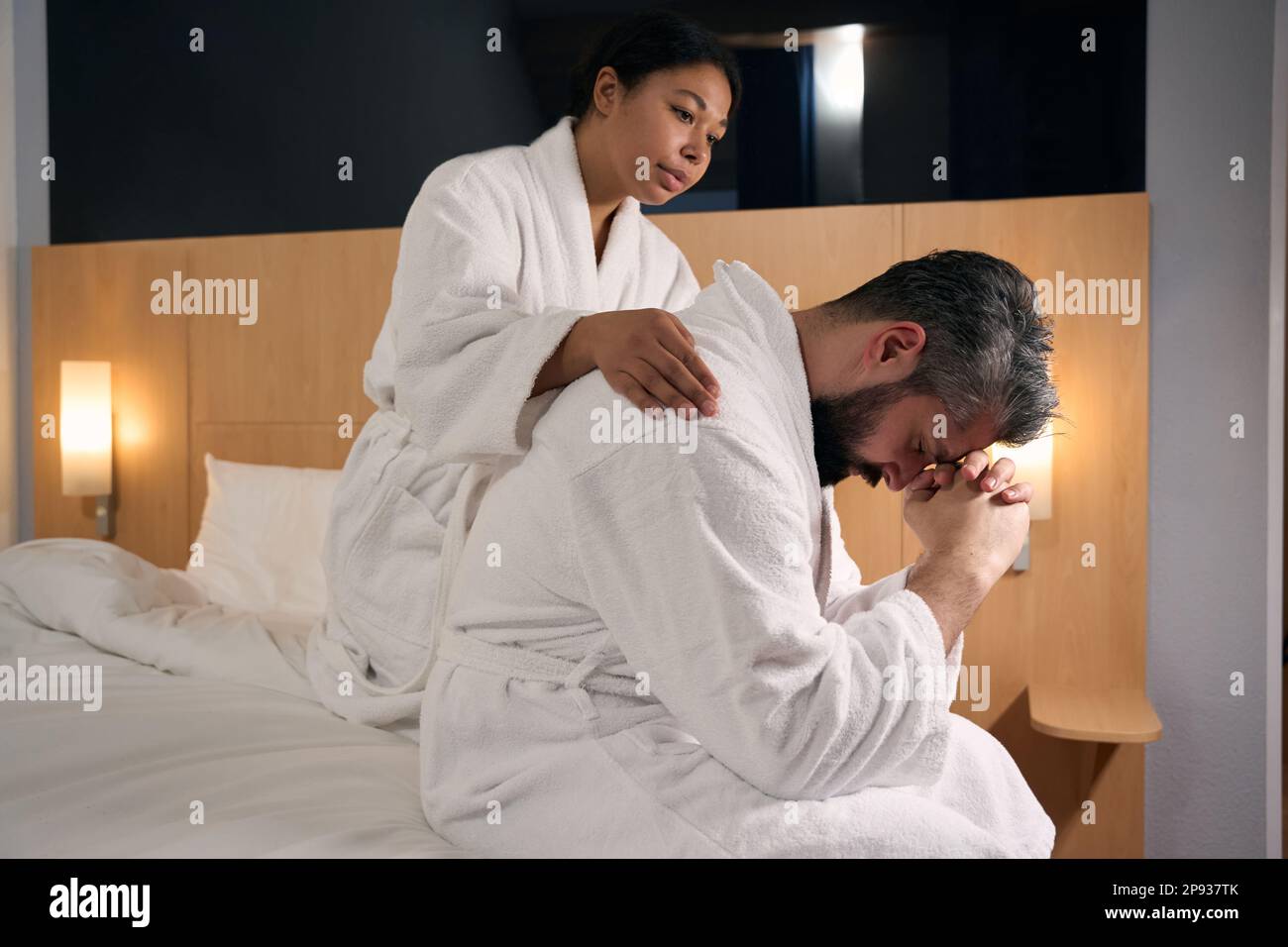 Caring woman comforting her depressed boyfriend in hotel room Stock ...
