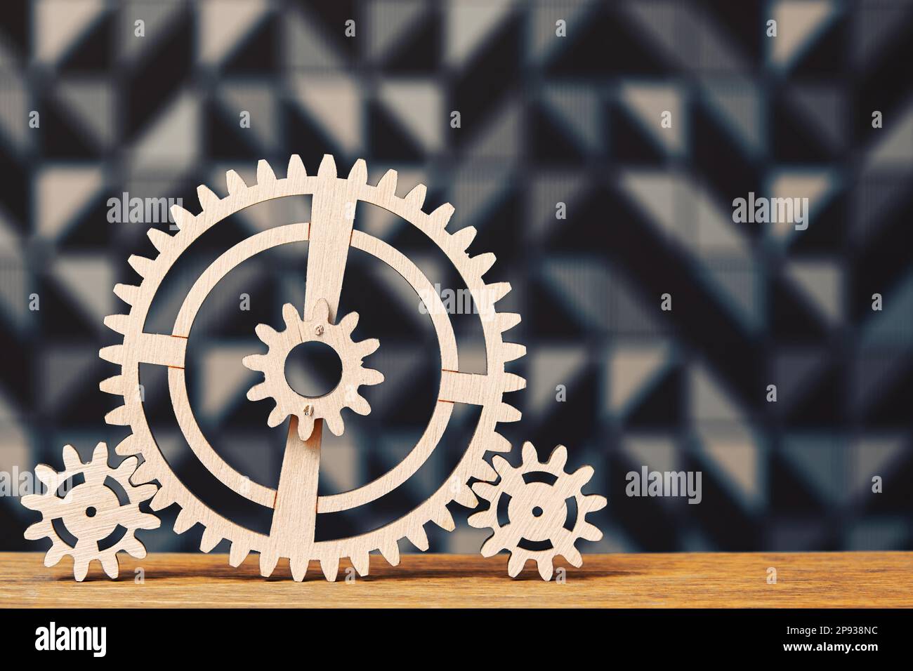 Several wooden cogwheels different sizes connected to each other on the ...