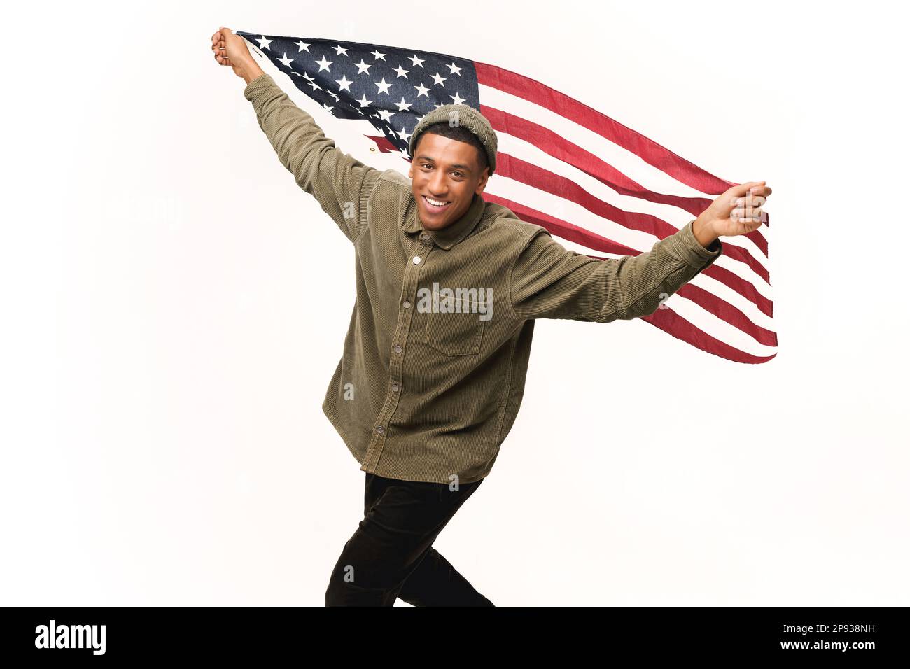 Cheerful African-American guy holding in hands american flag and ...