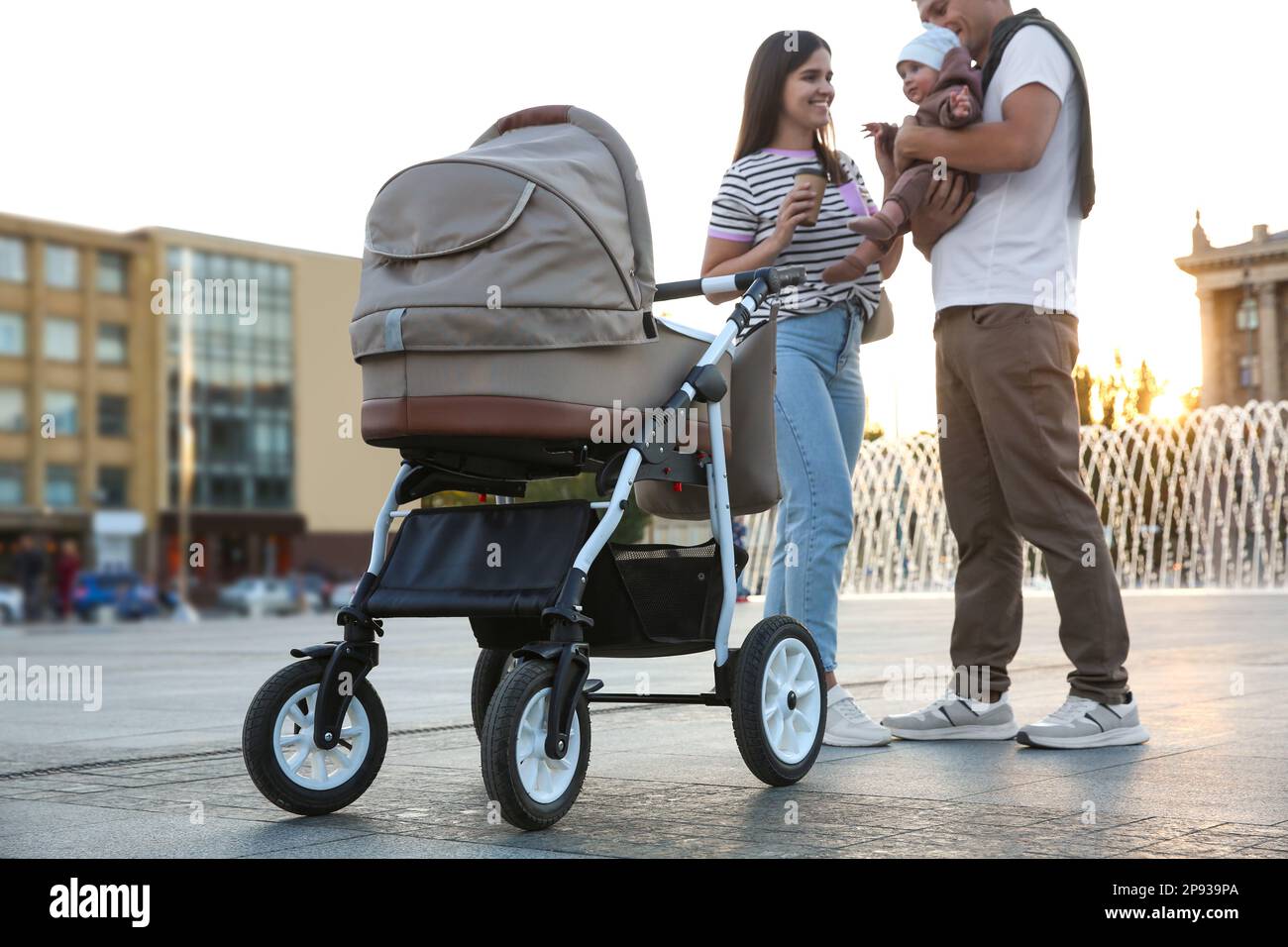 Happy parents walking with their baby outdoors Stock Photo - Alamy