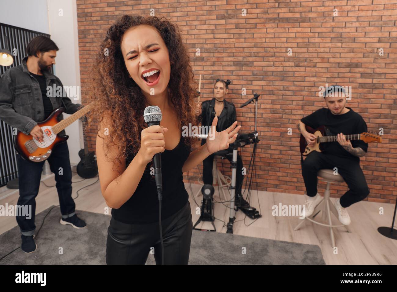 Music band performing in modern recording studio Stock Photo - Alamy