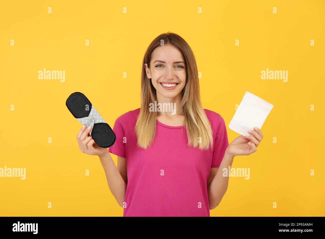 Happy young woman with disposable and reusable cloth menstrual pads on ...