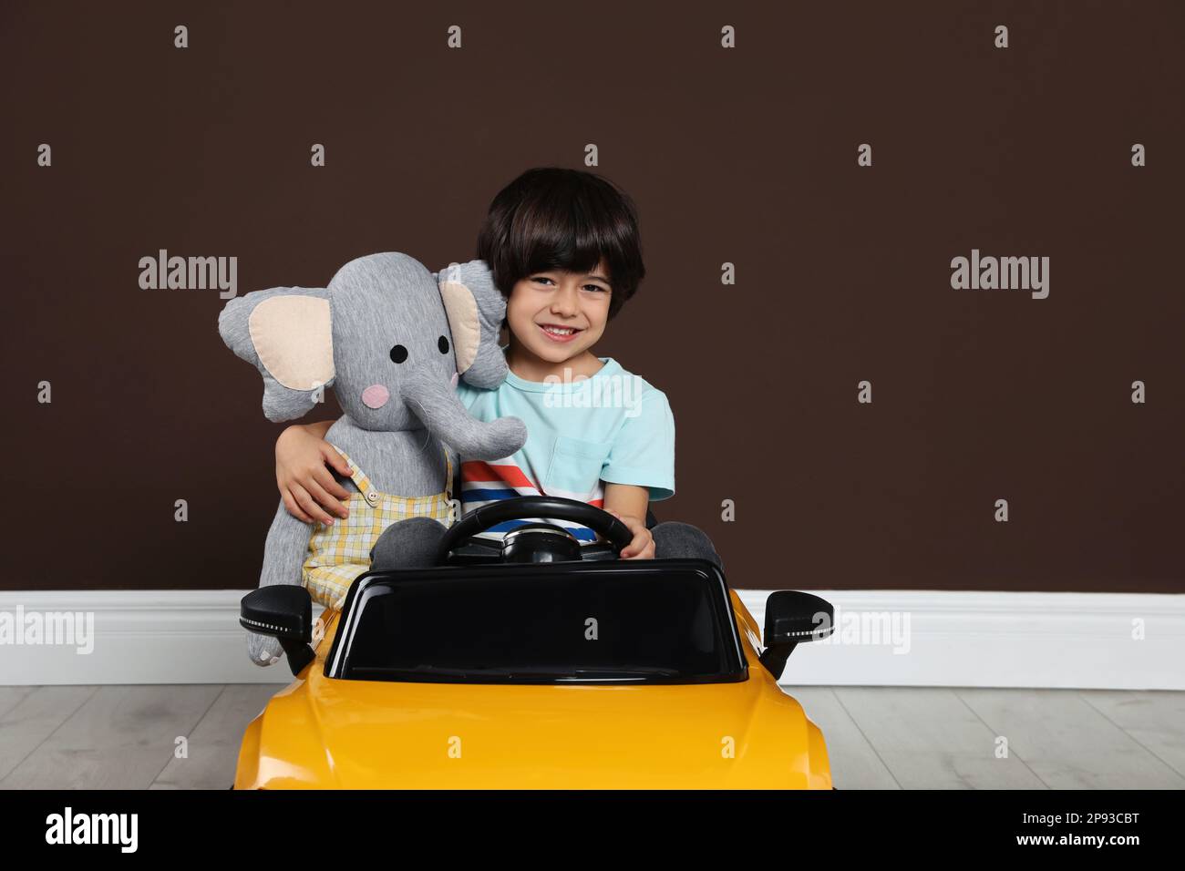 Child driving children toy car brown hi-res stock photography and ...