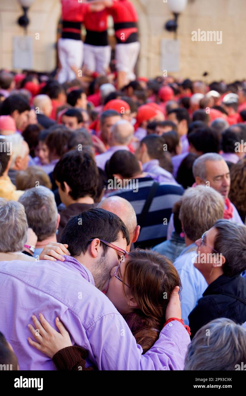 Couple of Colla Jove Xiquets de Tarragona kissing.In background ...