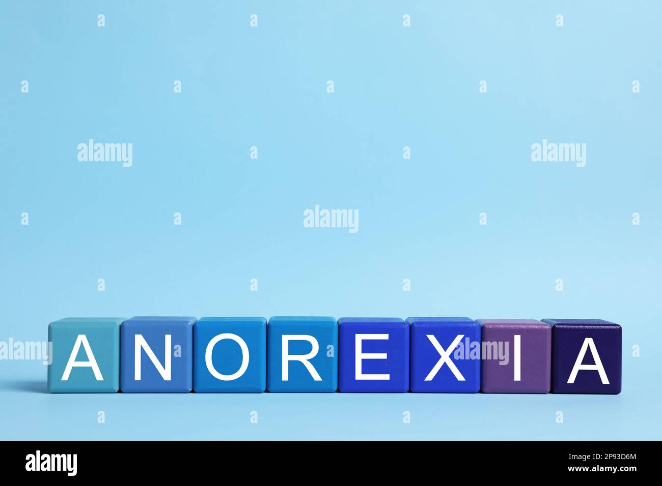 Word Anorexia made of colorful cubes with letters on light blue ...