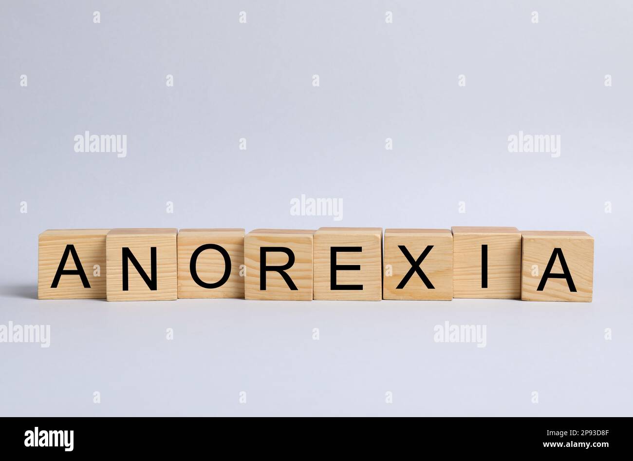 Word Anorexia made of wooden cubes with letters on light background ...