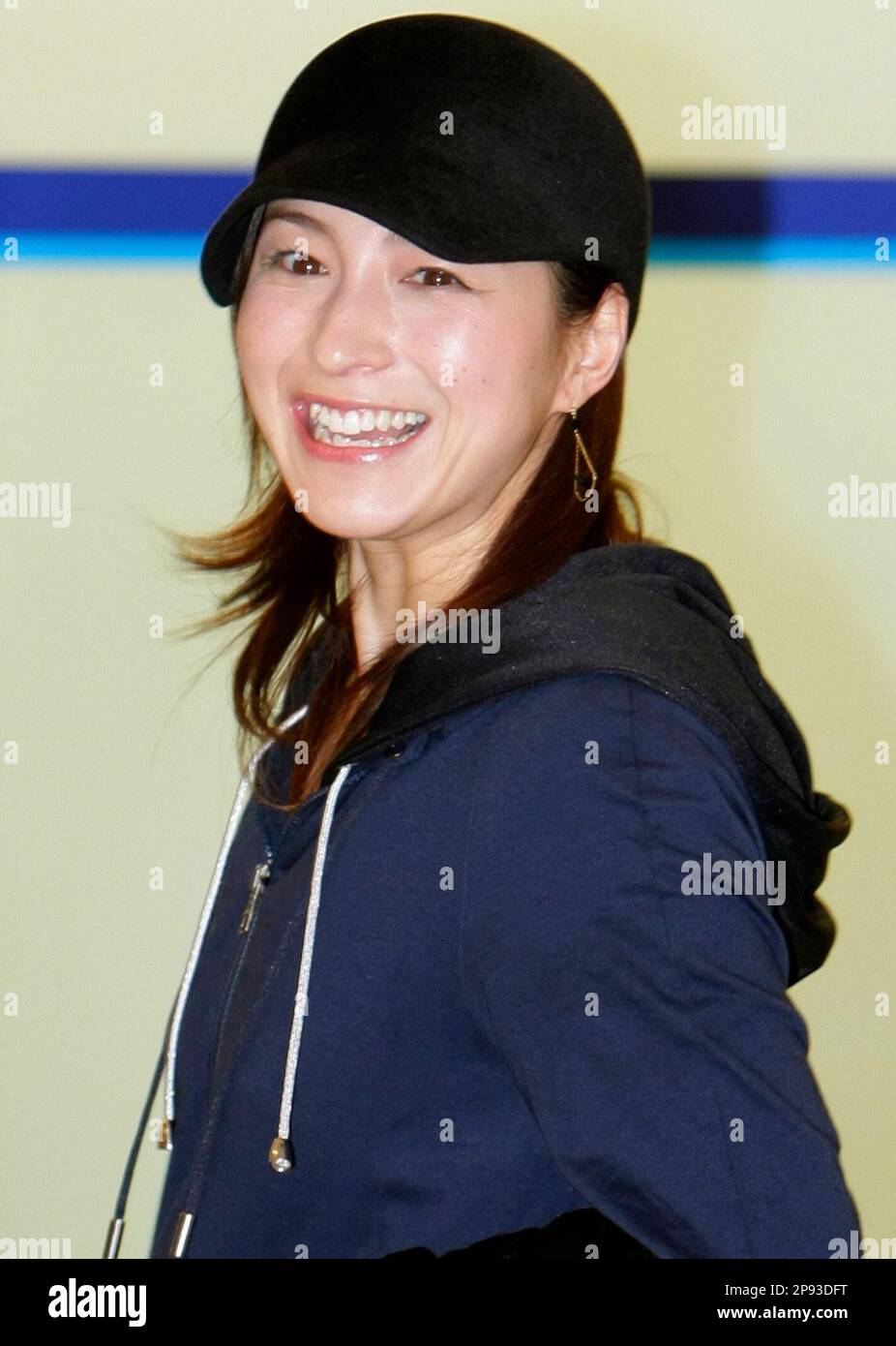 Japanese actress Ryoko Hirosue smiles upon her arrival at Narita ...