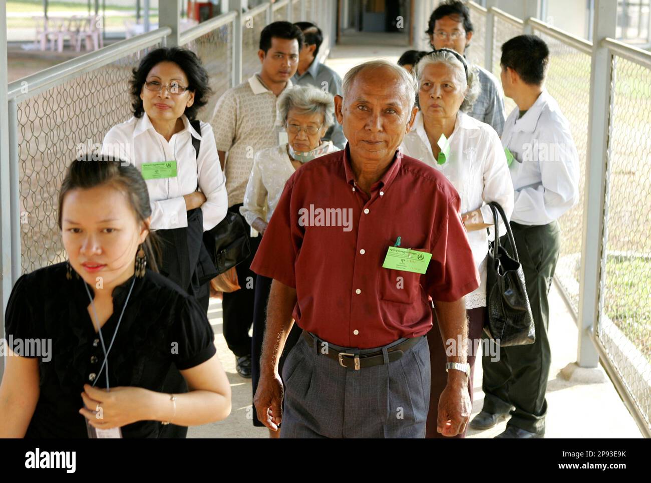 Cambodian Chum Mey, 76, center, looks on as he walks into the court ...