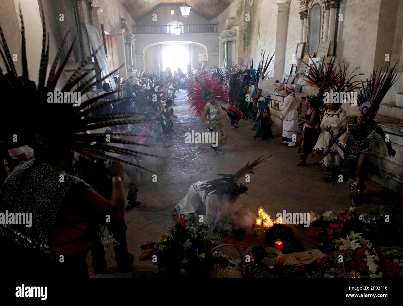 Dancers dressed in traditional costumes perform during an Aztec ...