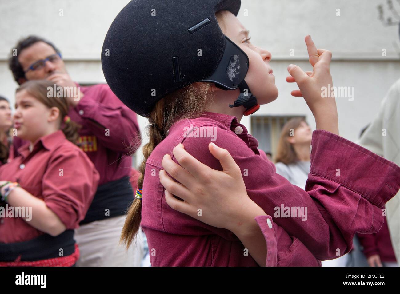 Superstitious`Enxaneta´looking the lifting of a human tower with ...