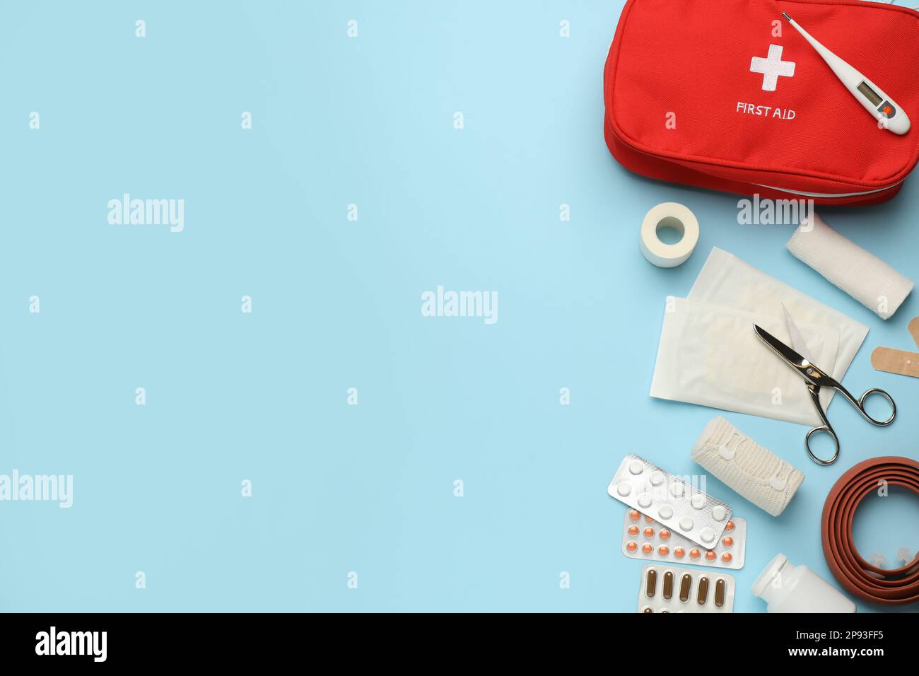 Flat lay composition with first aid kit on light blue background, space ...