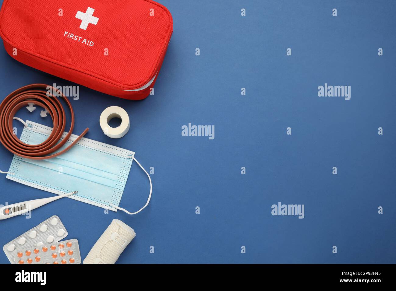 Flat lay composition with first aid kit on blue background, space for ...