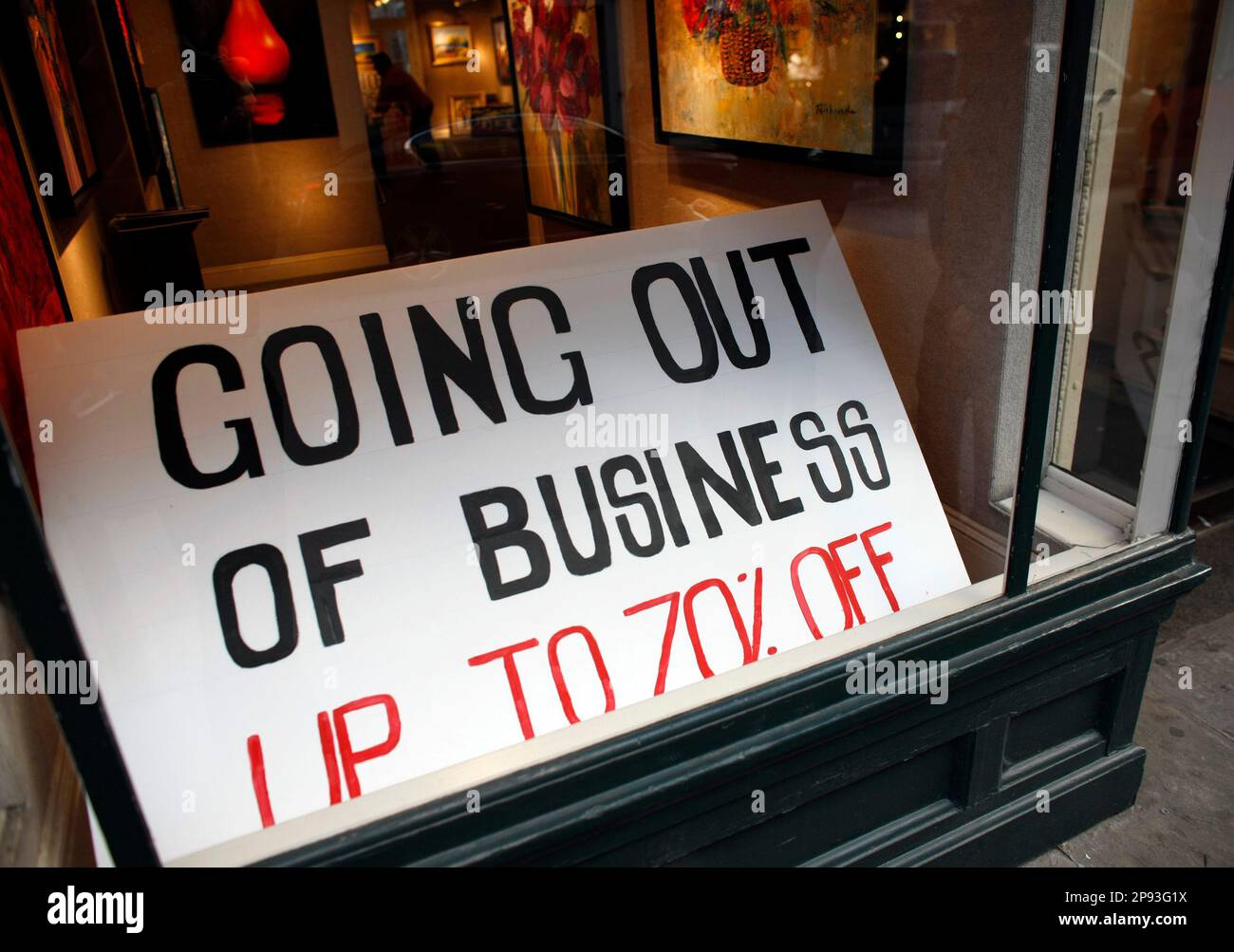 A hand-lettered sign stands in the window of an art gallery headed for ...